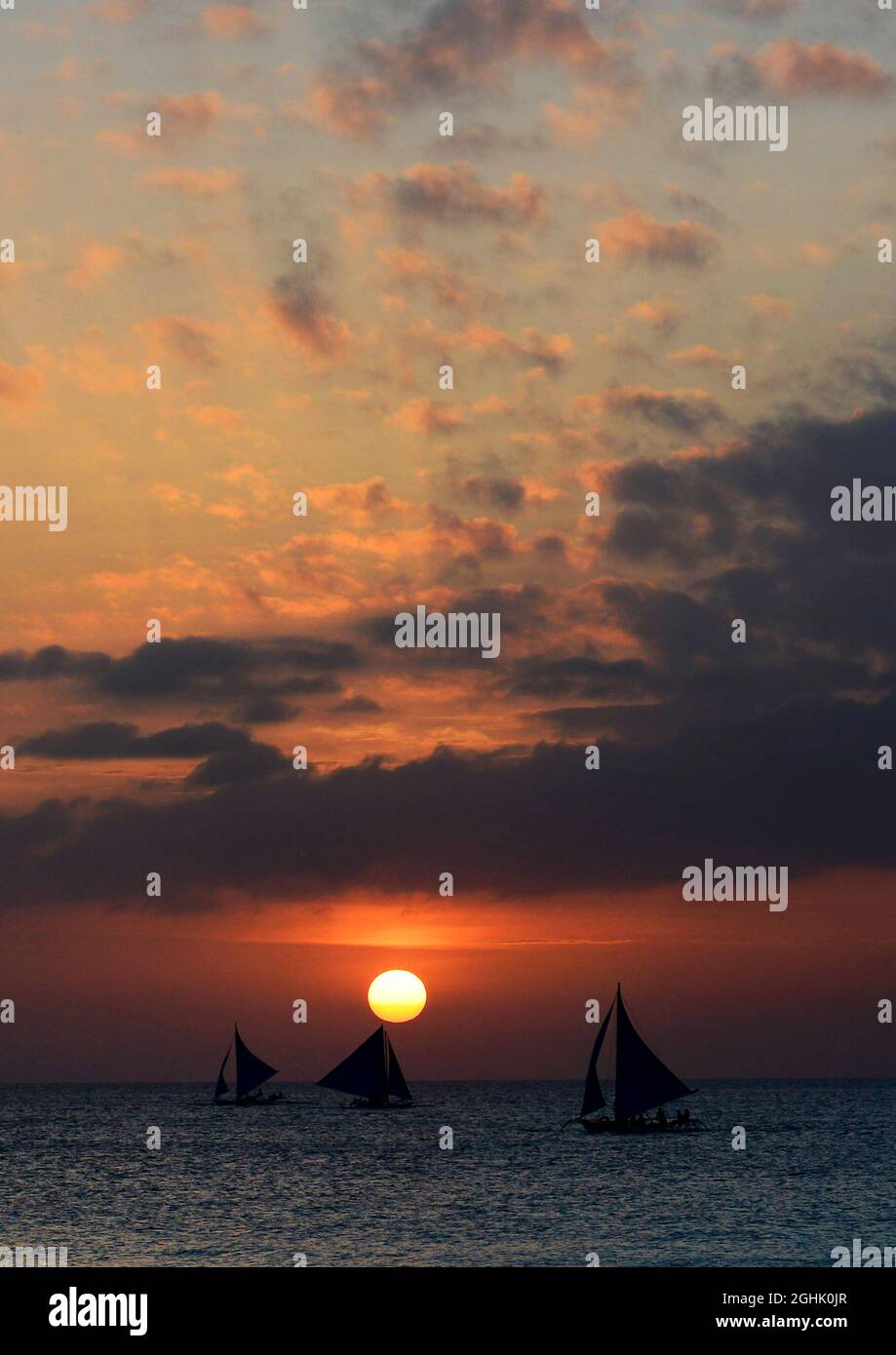 A romantic sunset enjoyed from the beach in Boracay island, Aklan ...