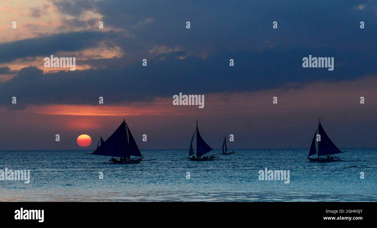 A romantic sunset enjoyed from the beach in Boracay island, Aklan ...
