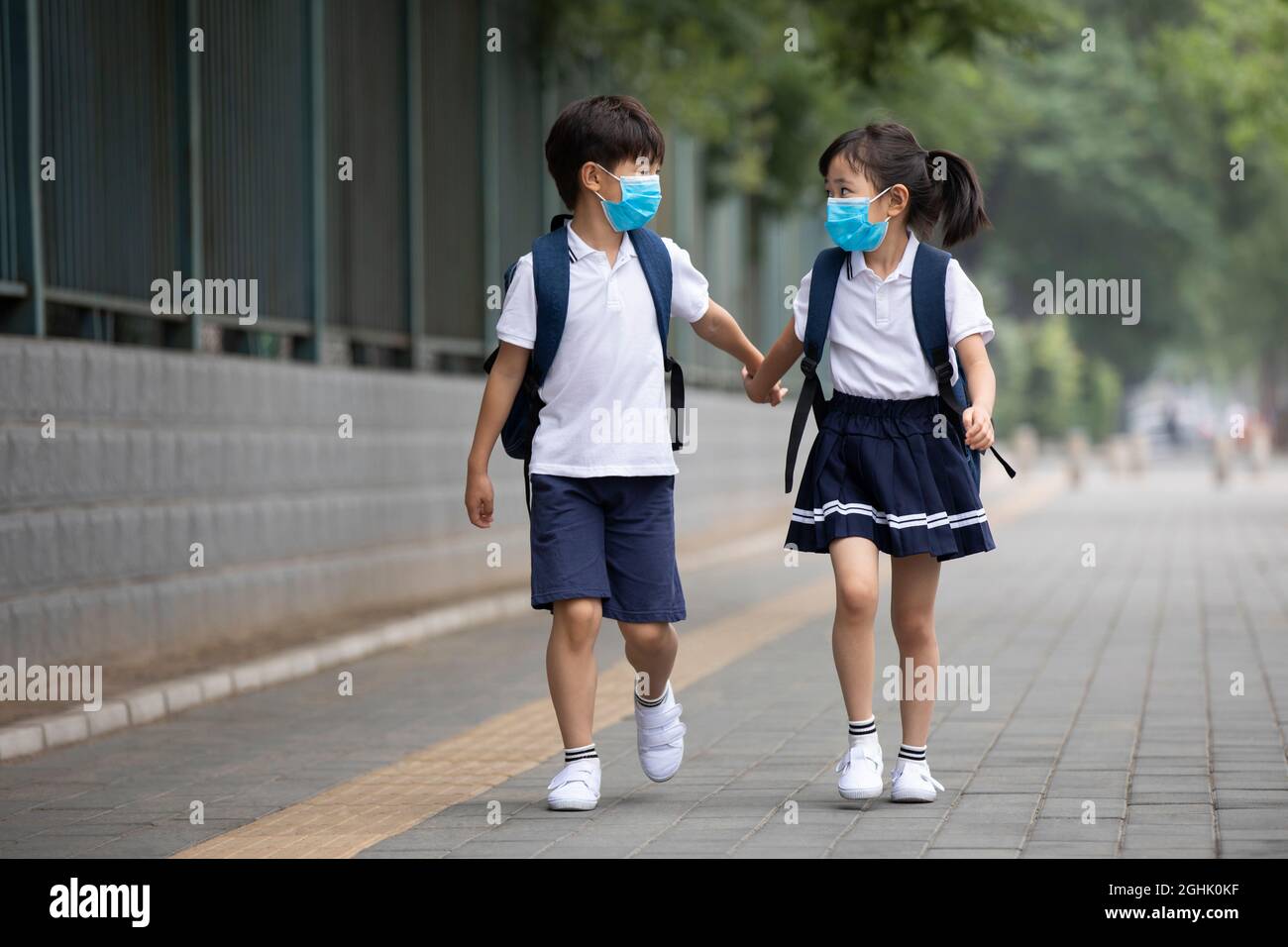 Two pupils wearing surgical masks to go to school Stock Photo - Alamy