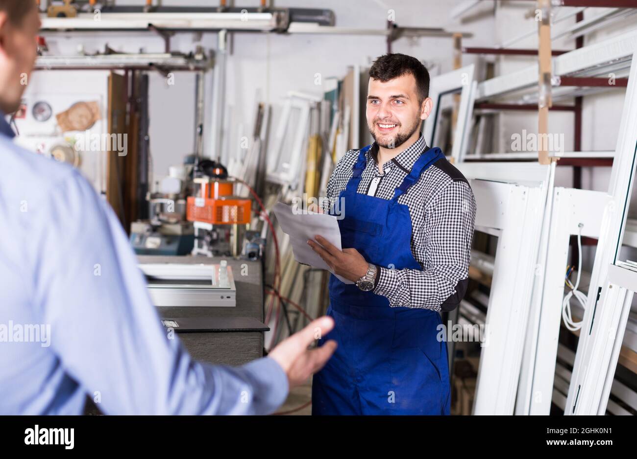 Smiling foreman is taking order from customer Stock Photo - Alamy