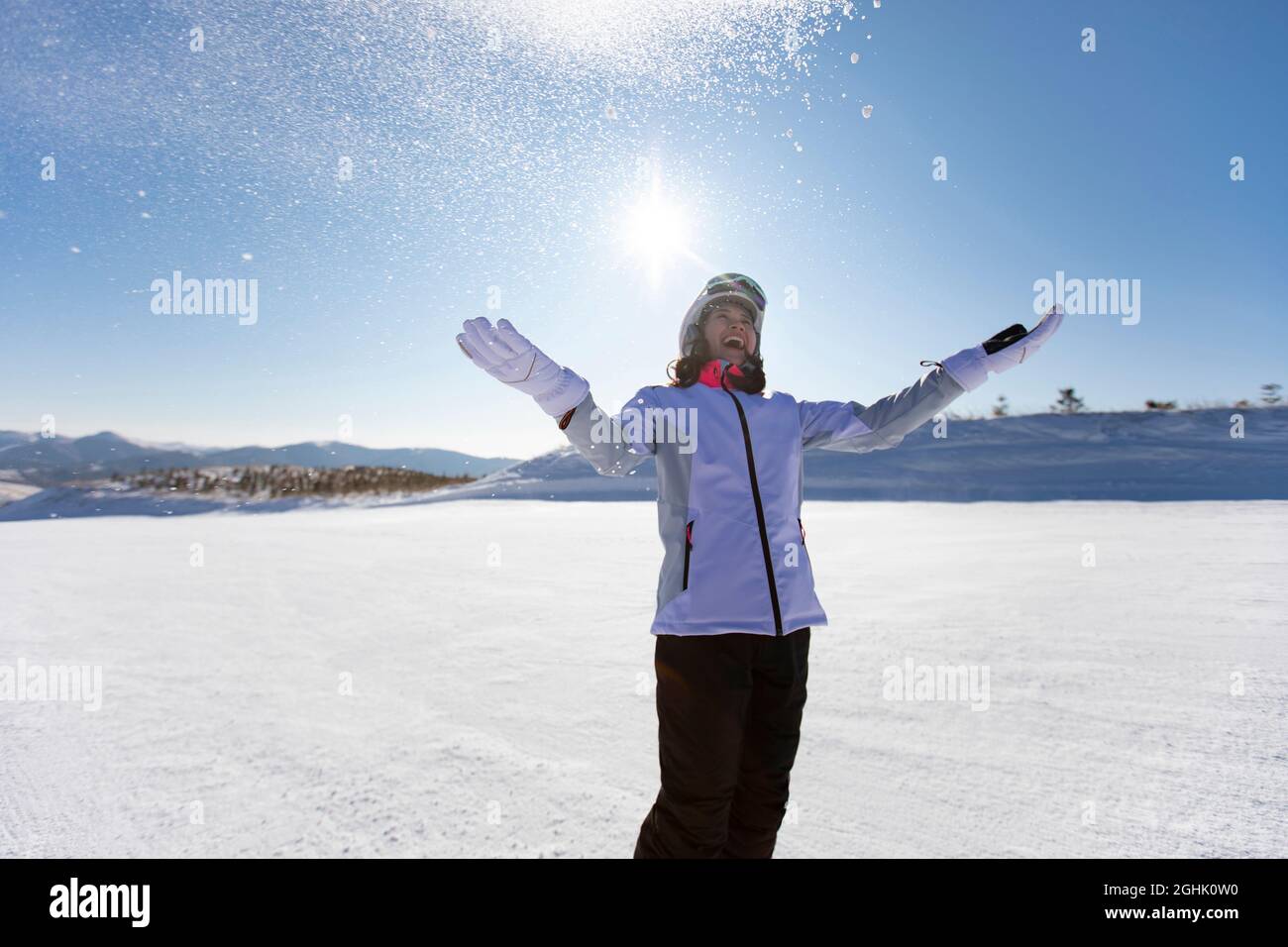 Young woman relaxing in ski resort Stock Photo - Alamy