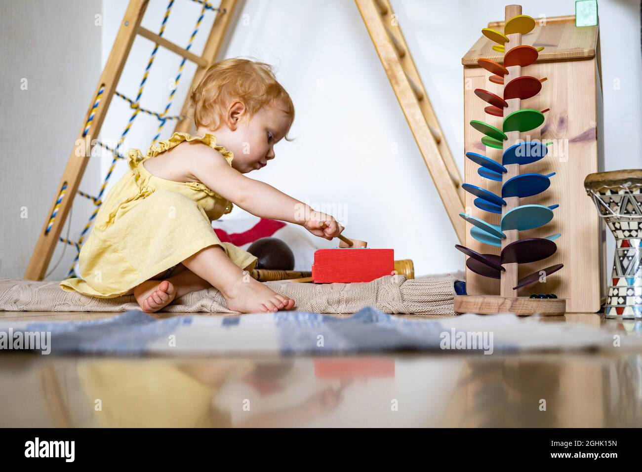 Cute baby girl playing wooden childish xylophone ecology toys Maria ...