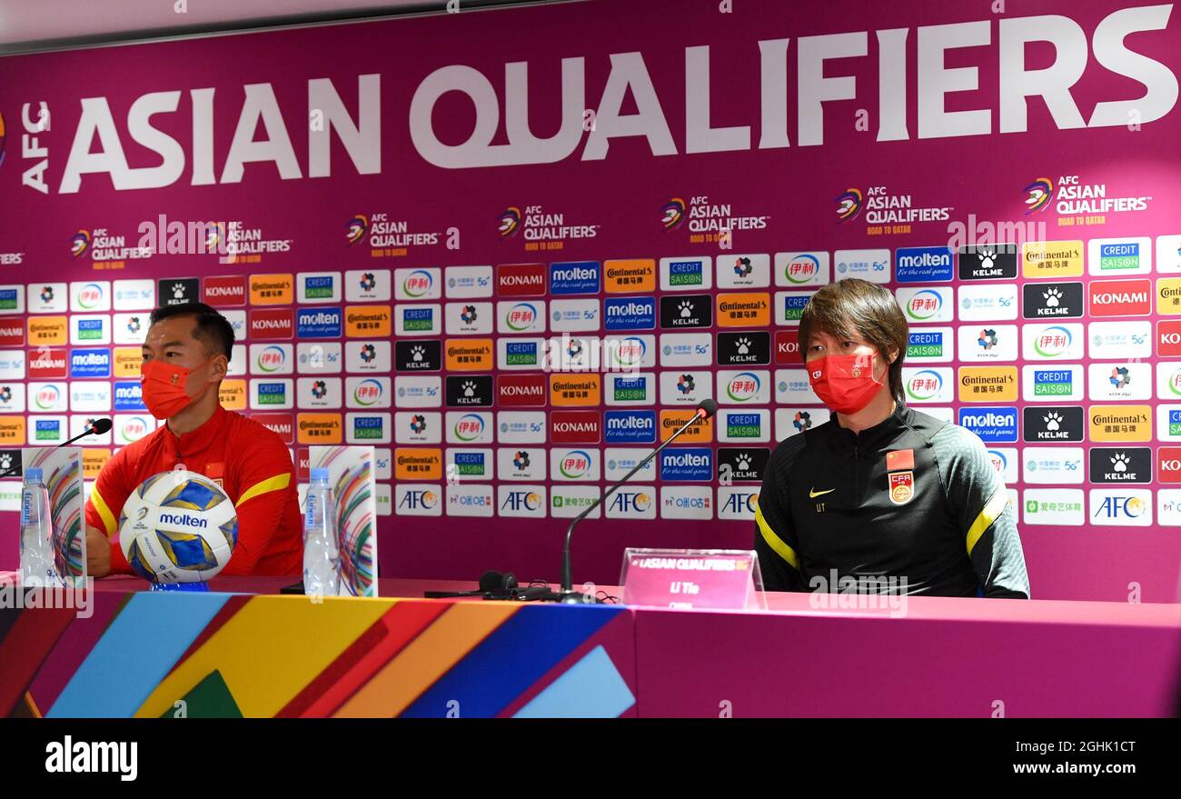 Doha, Qatar. 6th Sep, 2021. Li Tie (R), head coach of China, and Wu Xi ...
