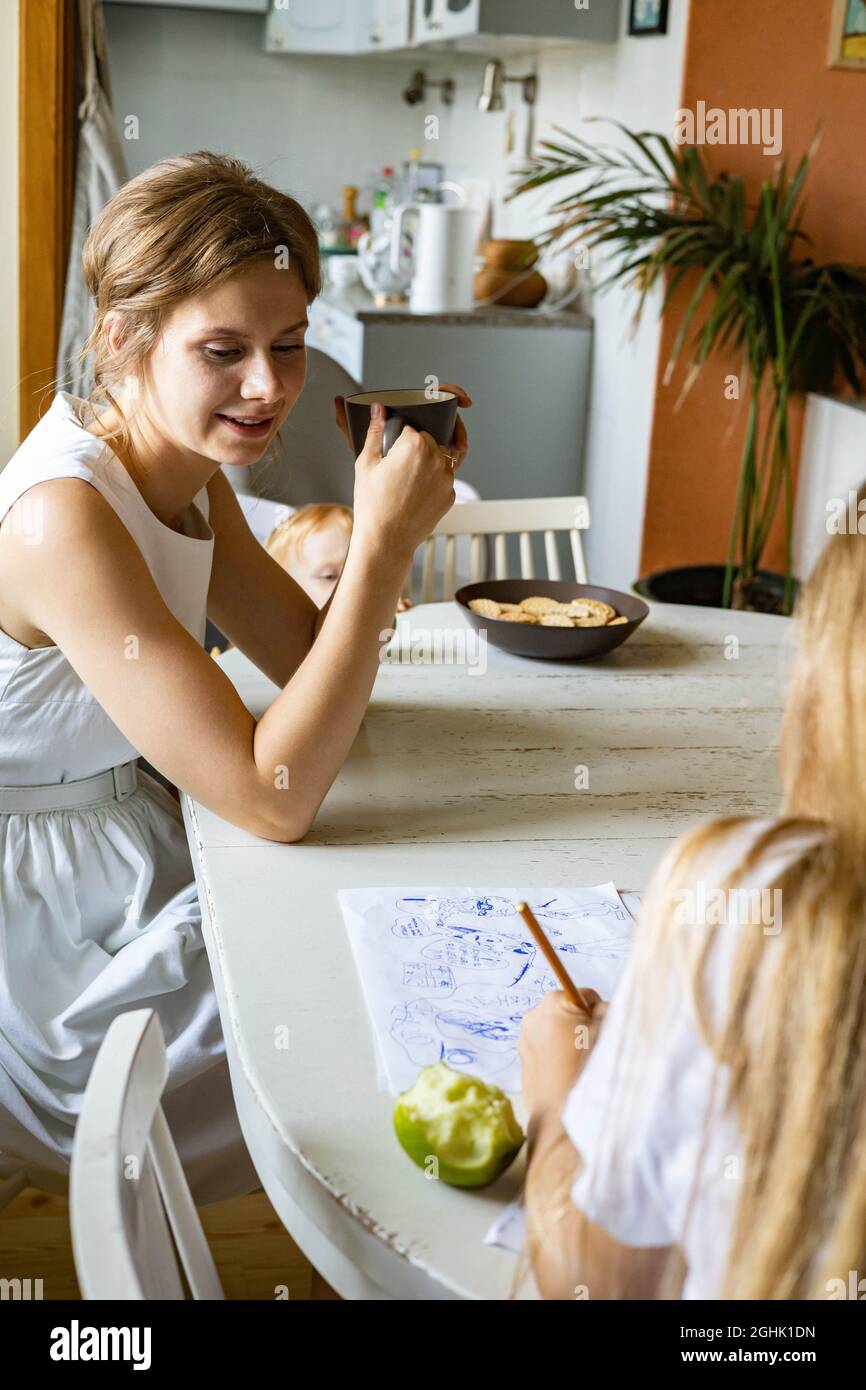 Teenager girl drawing picture on paper sheet or making notes use pen ...