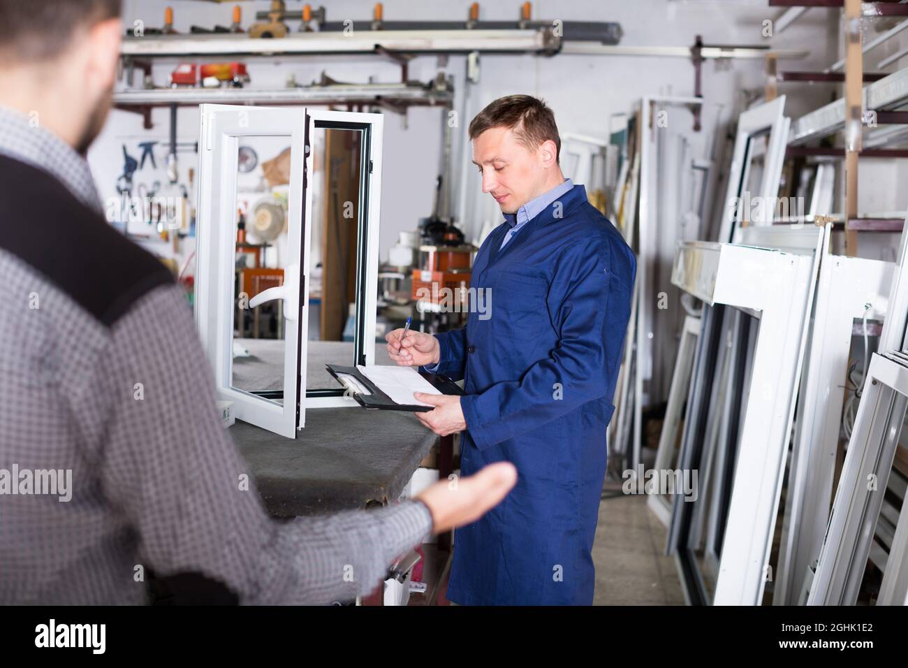Smiling workman is taking order from customer Stock Photo - Alamy