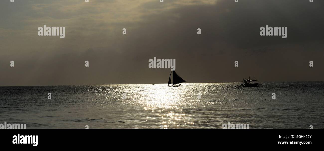 A romantic sunset enjoyed from the beach in Boracay island, Aklan ...