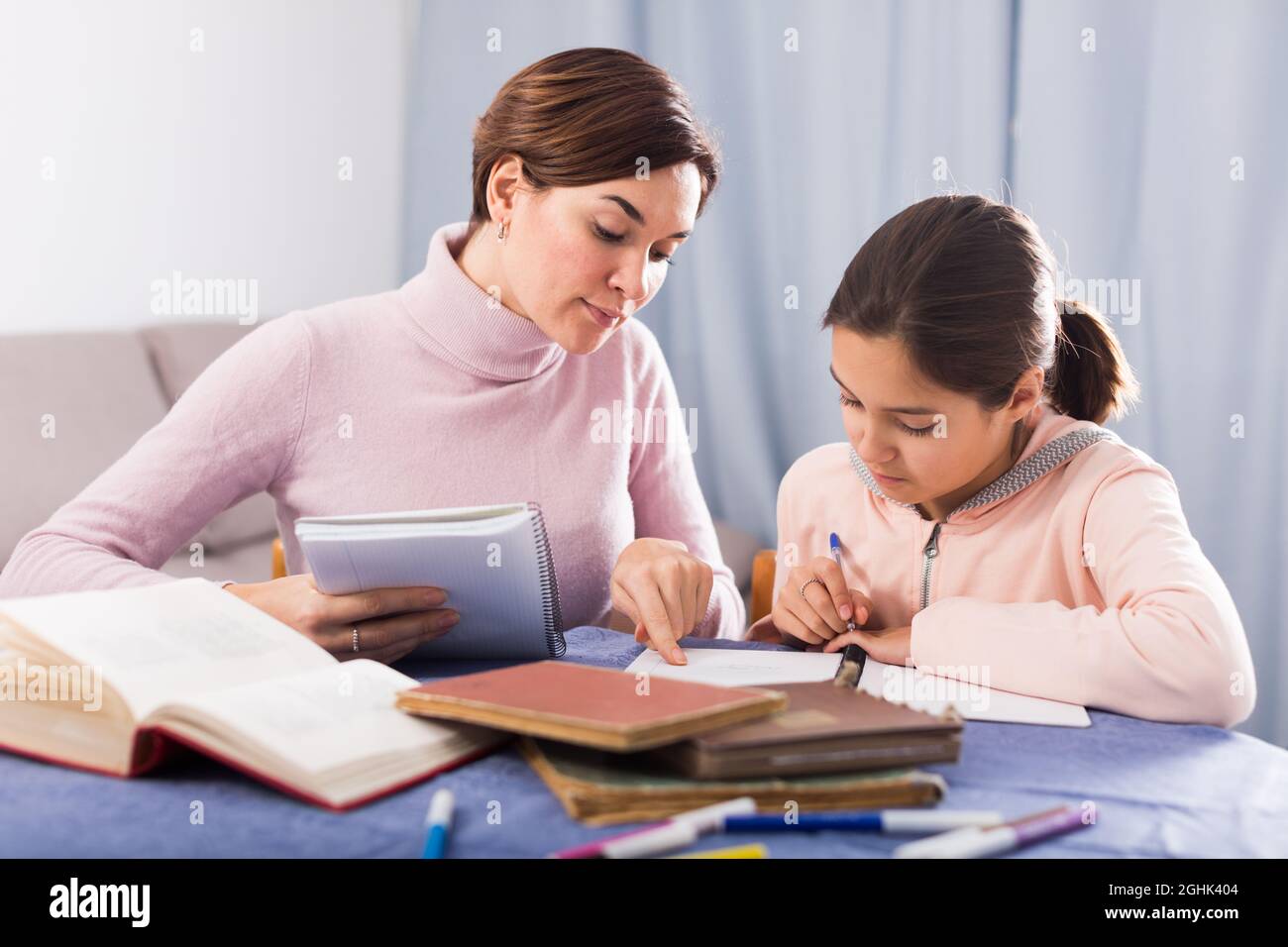 Mother and daughter doing school homework Stock Photo - Alamy