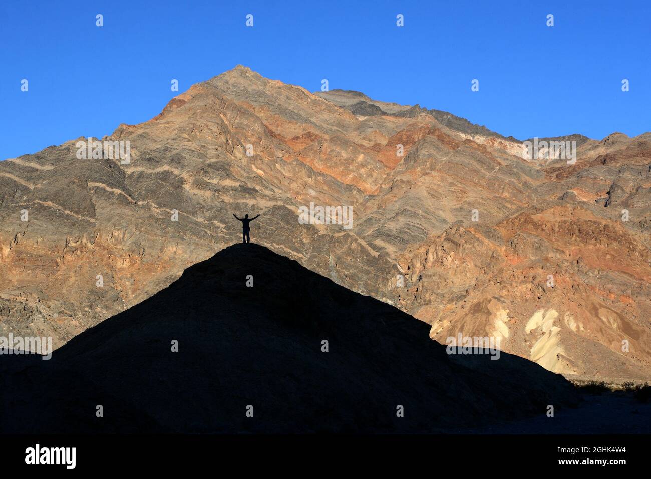 Silhouette of man celebrating with outstretched arms with backdrop of ...