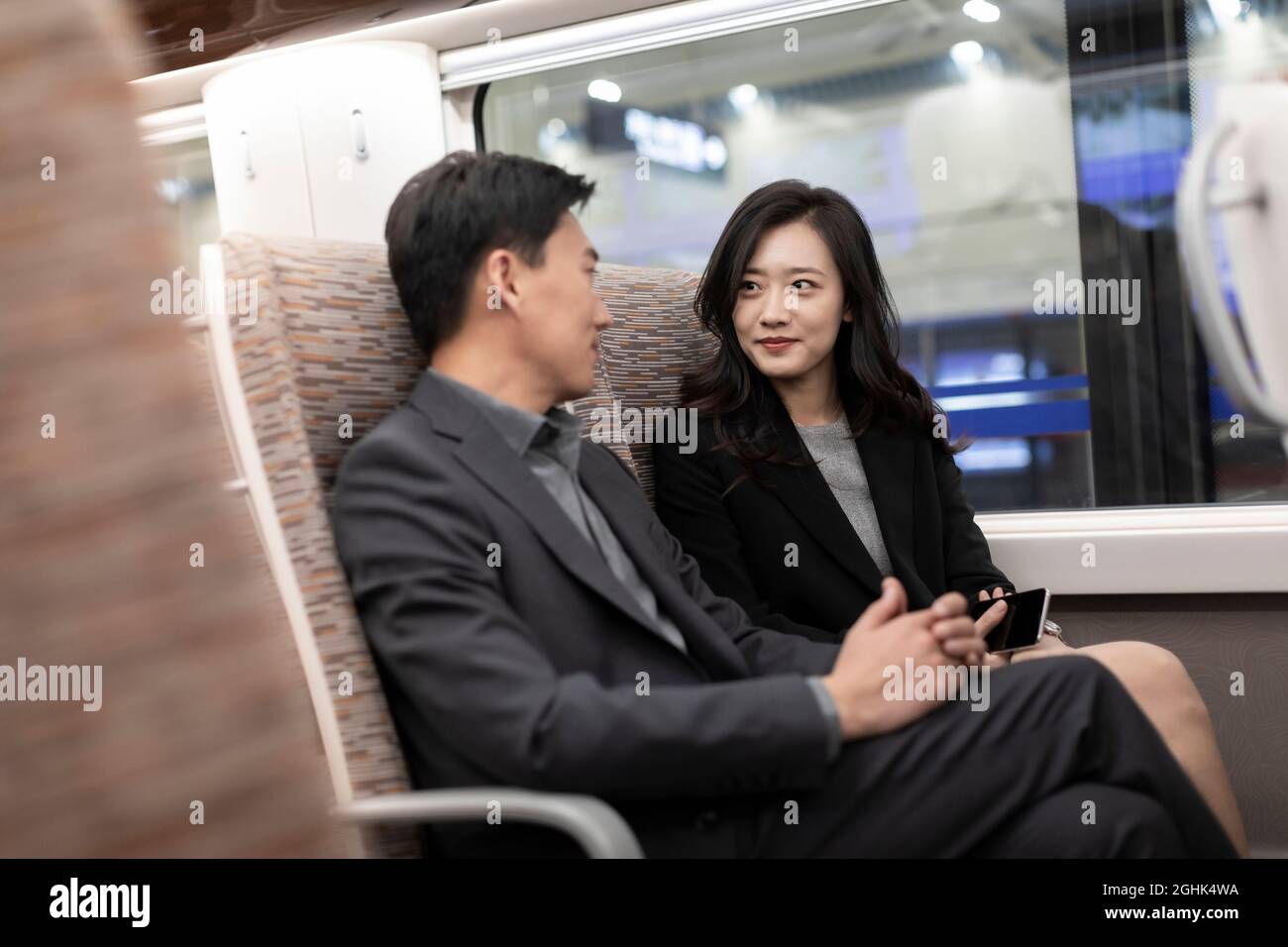 Successful business people talking on high-speed train Stock Photo - Alamy