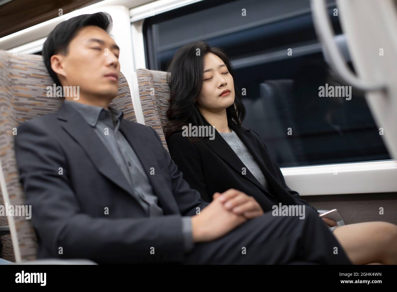 Successful business people resting on high-speed train Stock Photo - Alamy