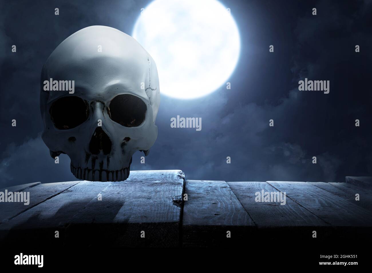 Human skull on wooden table with the night scene background Stock Photo ...
