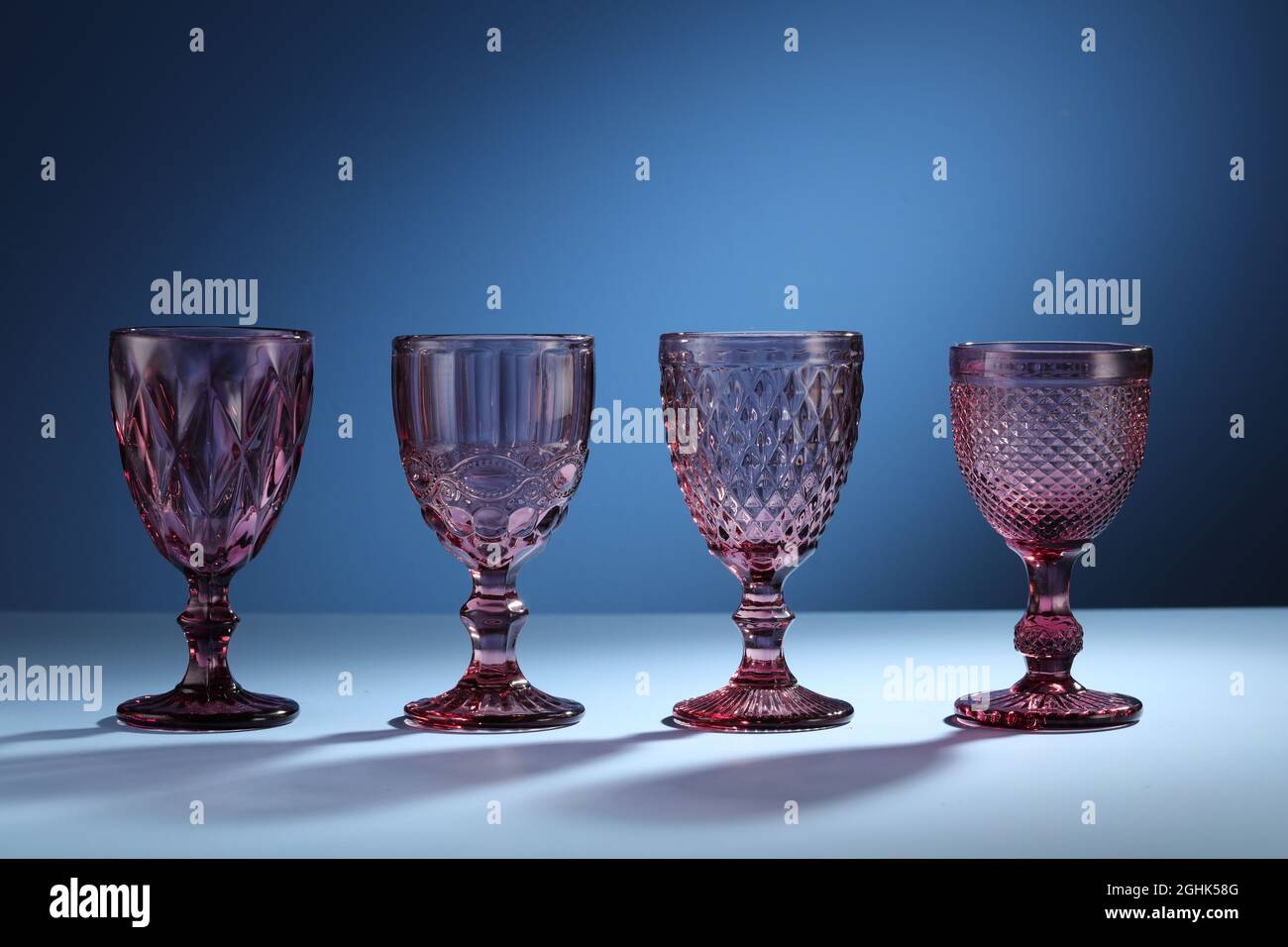 collection of pink cups on a blue background Stock Photo - Alamy