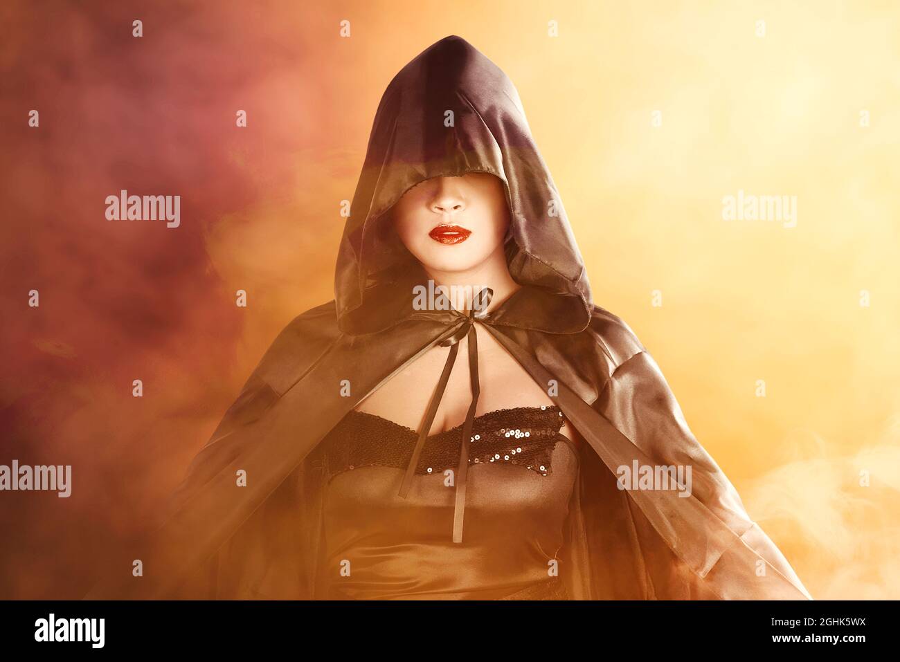 Asian witch woman with a cloak standing with dramatic background Stock ...