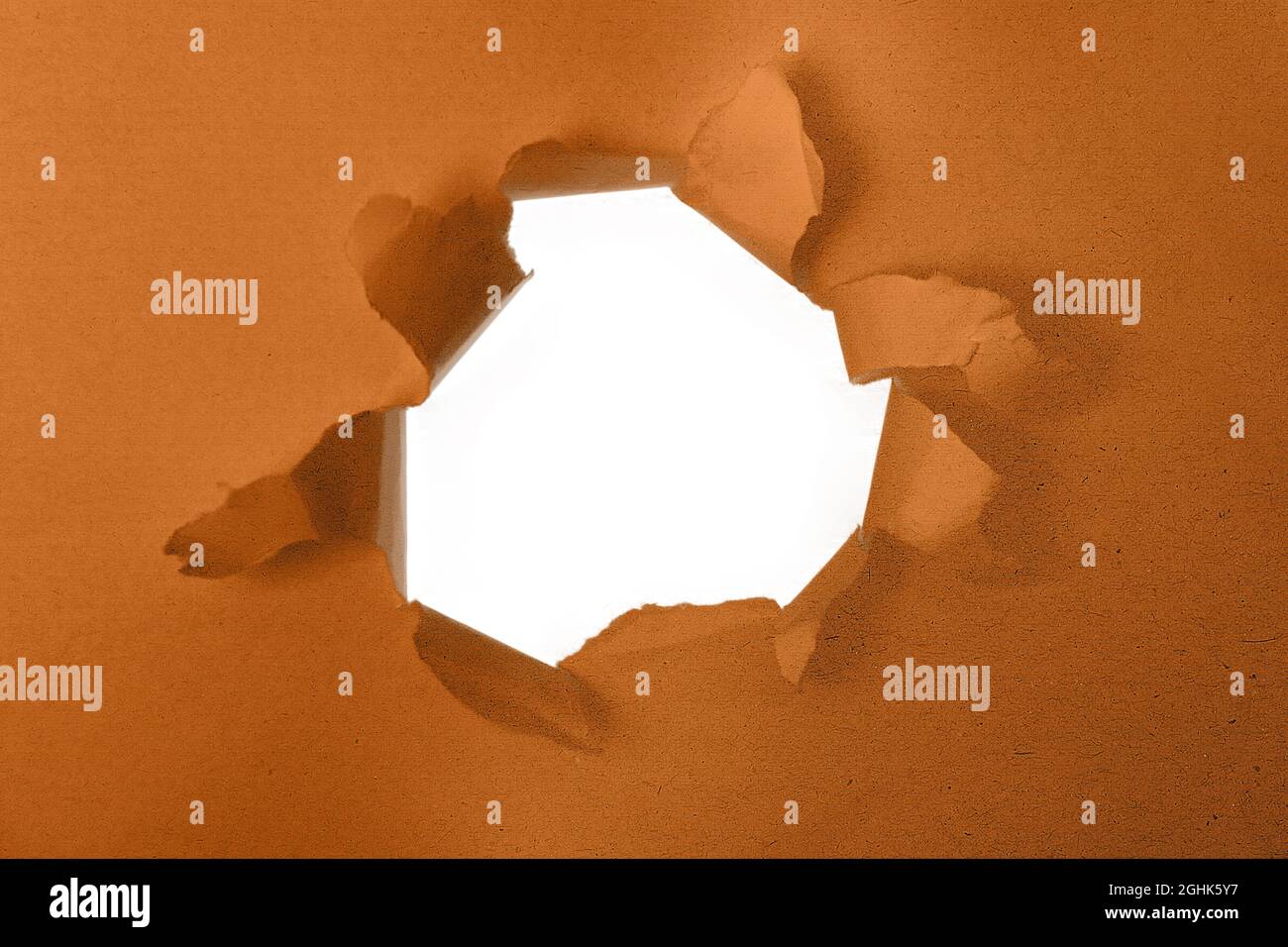 Paper with a hole torn in the middle with white background Stock Photo ...