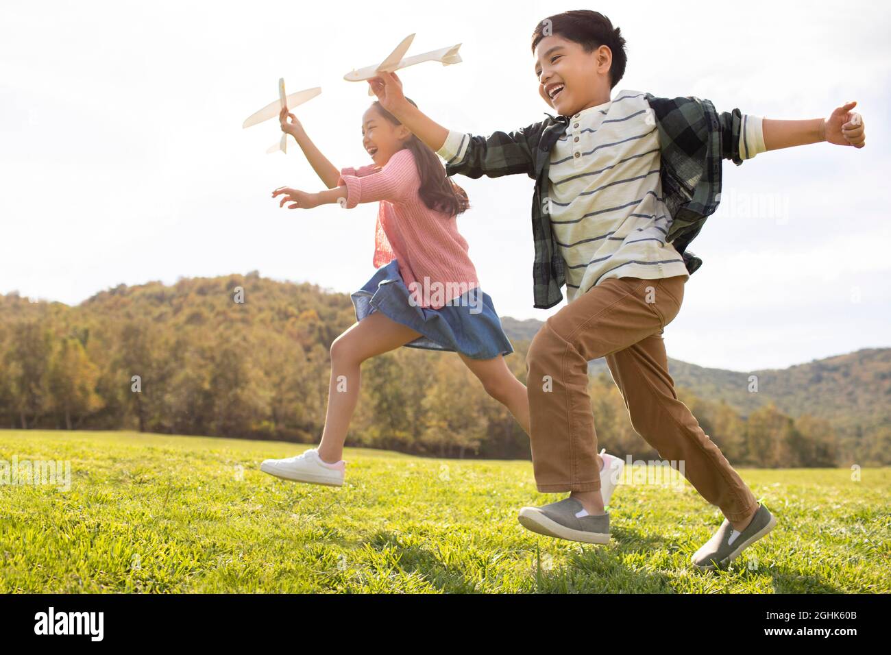 Happy children playing on meadow Stock Photo - Alamy