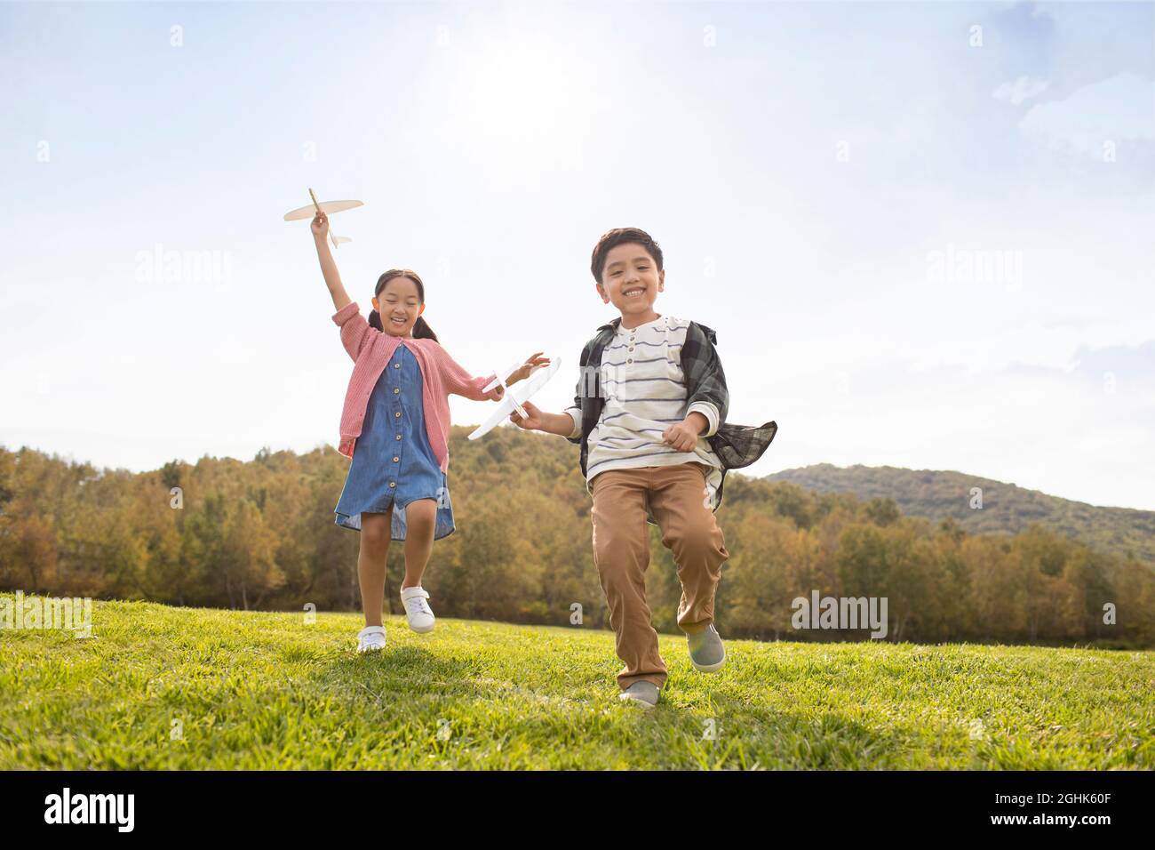 Happy children playing on meadow Stock Photo - Alamy