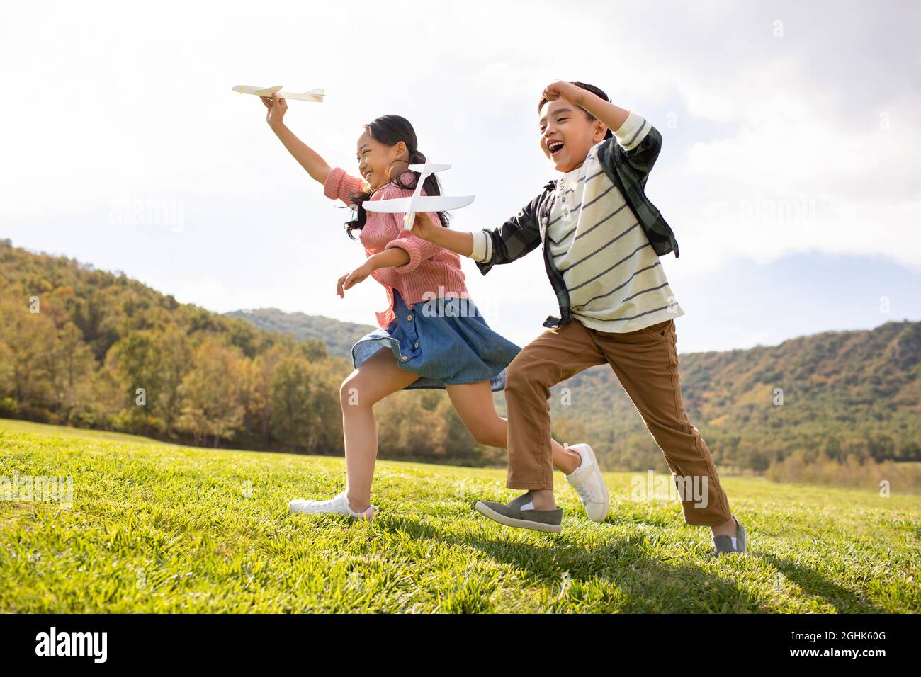Happy children playing on meadow Stock Photo - Alamy
