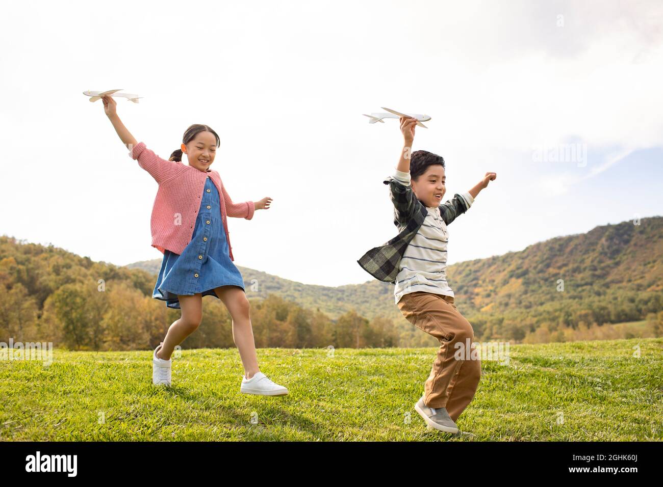 Happy children playing on meadow Stock Photo - Alamy