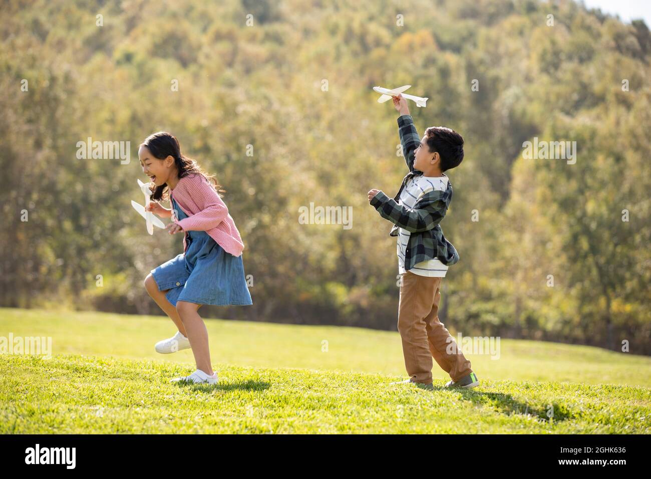 Happy children playing on meadow Stock Photo - Alamy