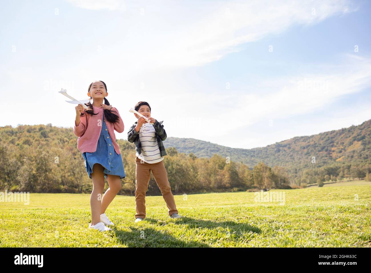Happy children playing on meadow Stock Photo - Alamy