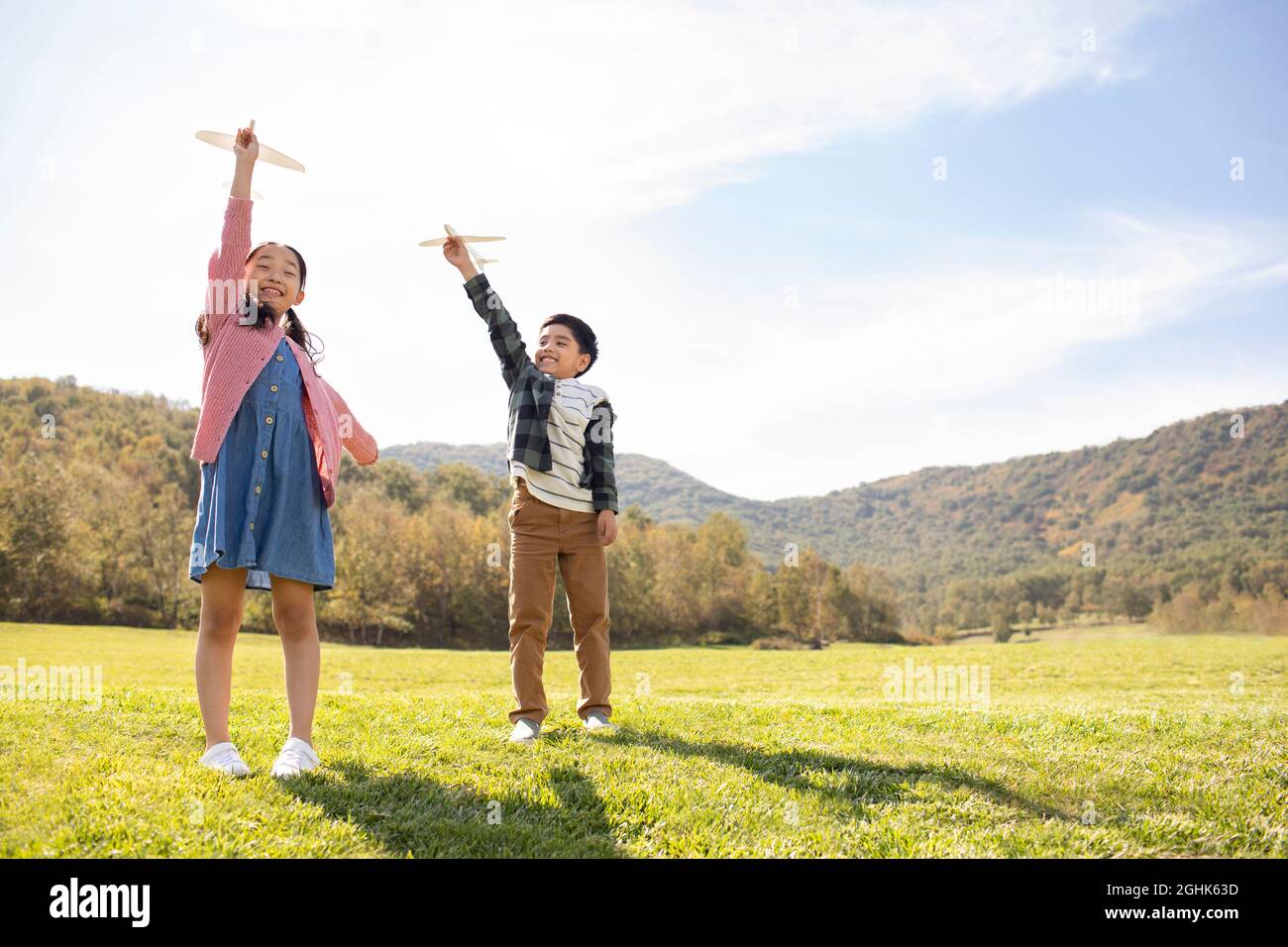 Happy children playing on meadow Stock Photo - Alamy