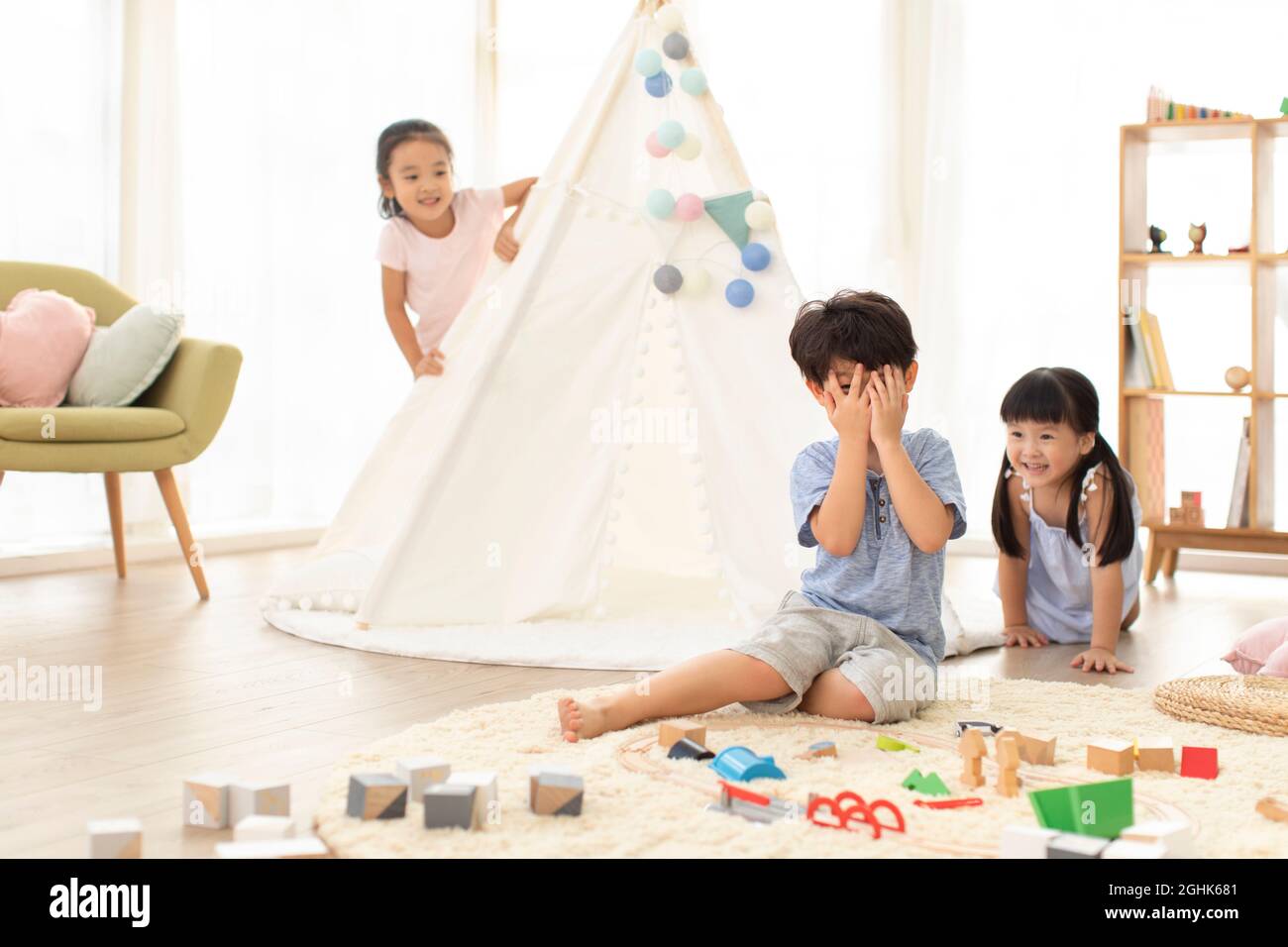 Three girls playing hide seek hi-res stock photography and images - Alamy