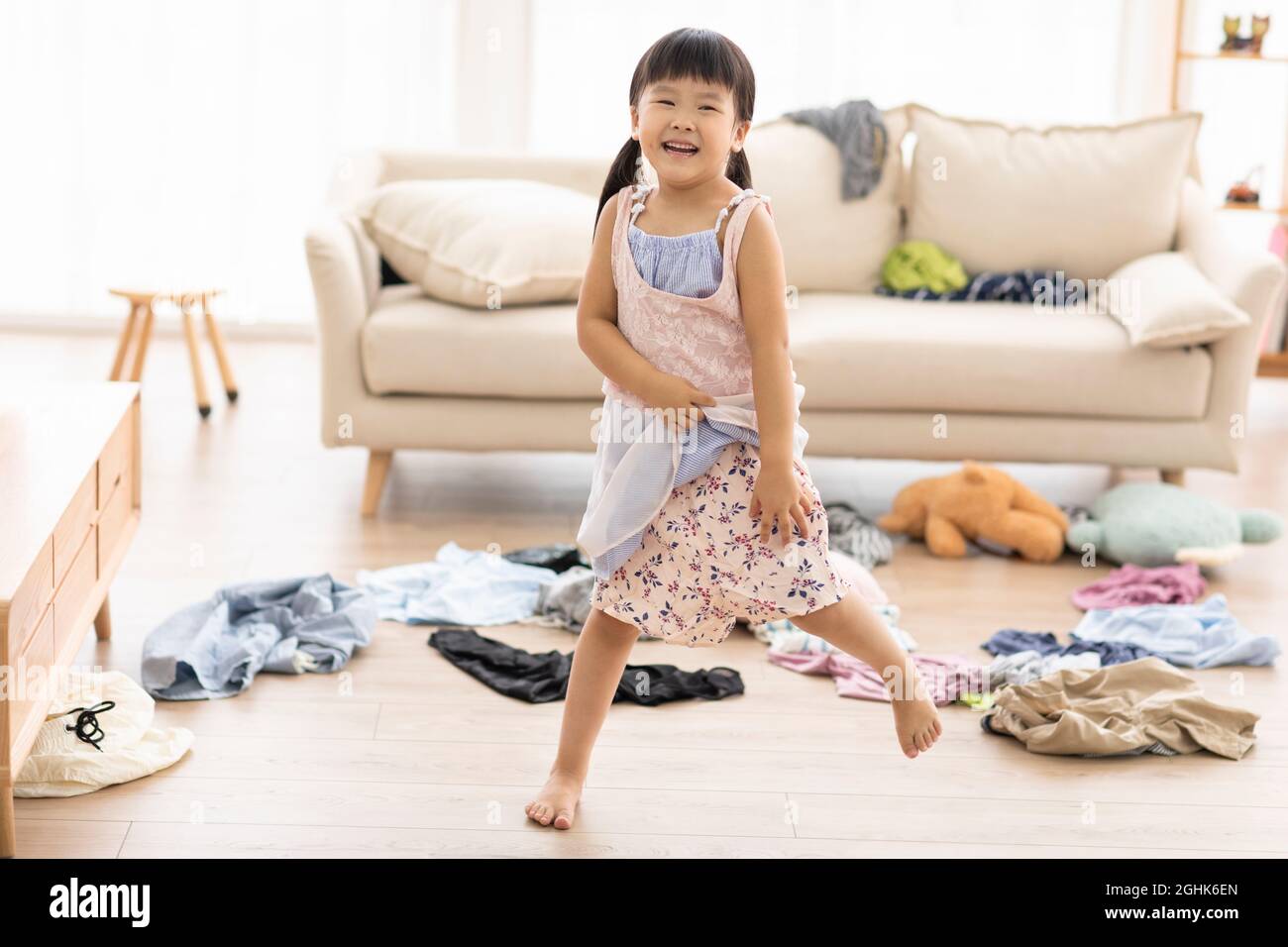 Cute girl dressing up in living room Stock Photo - Alamy