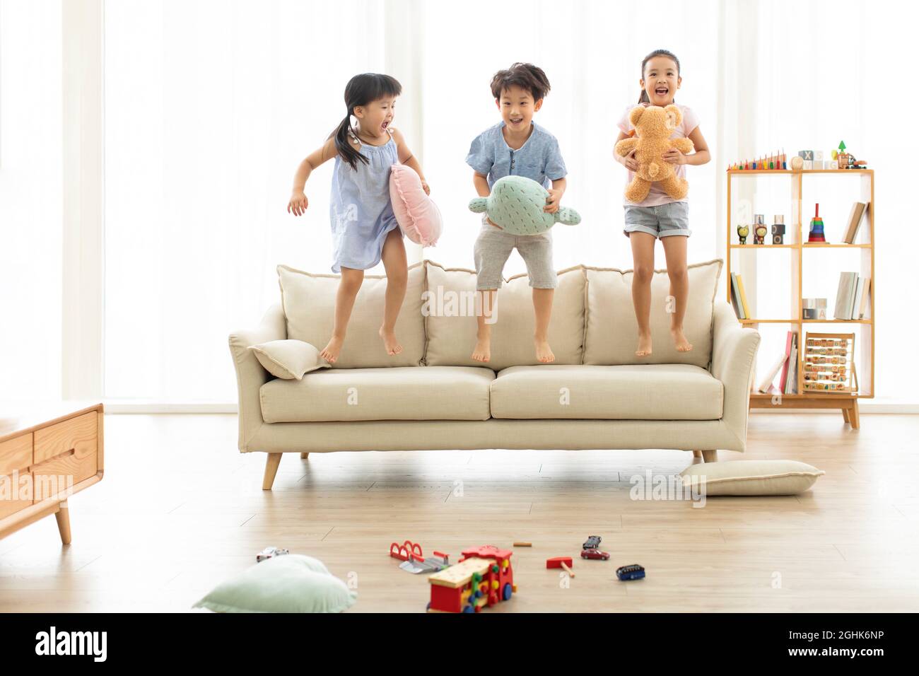 Cute children playing in living room Stock Photo - Alamy