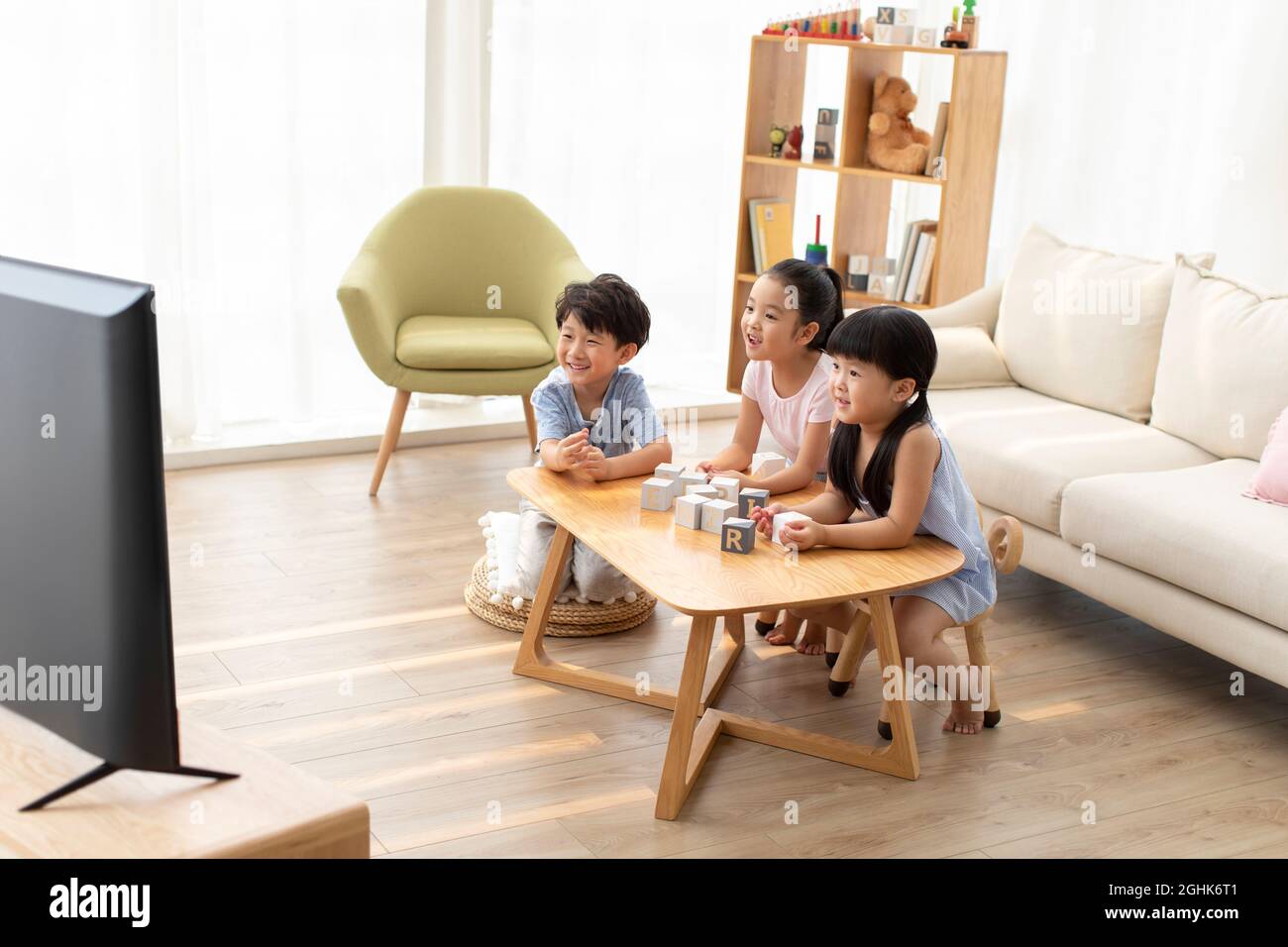 Cute children watching TV in living room Stock Photo - Alamy