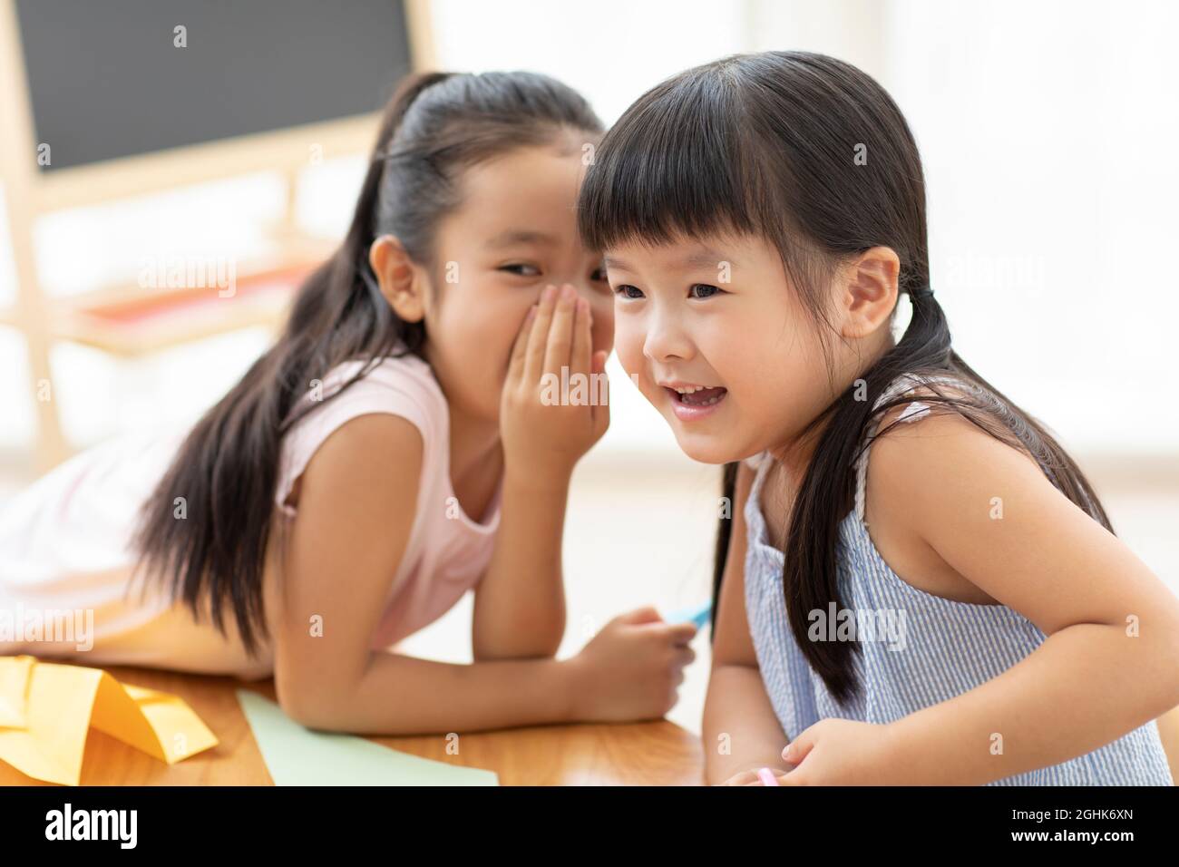 Cute children playing in living room Stock Photo - Alamy