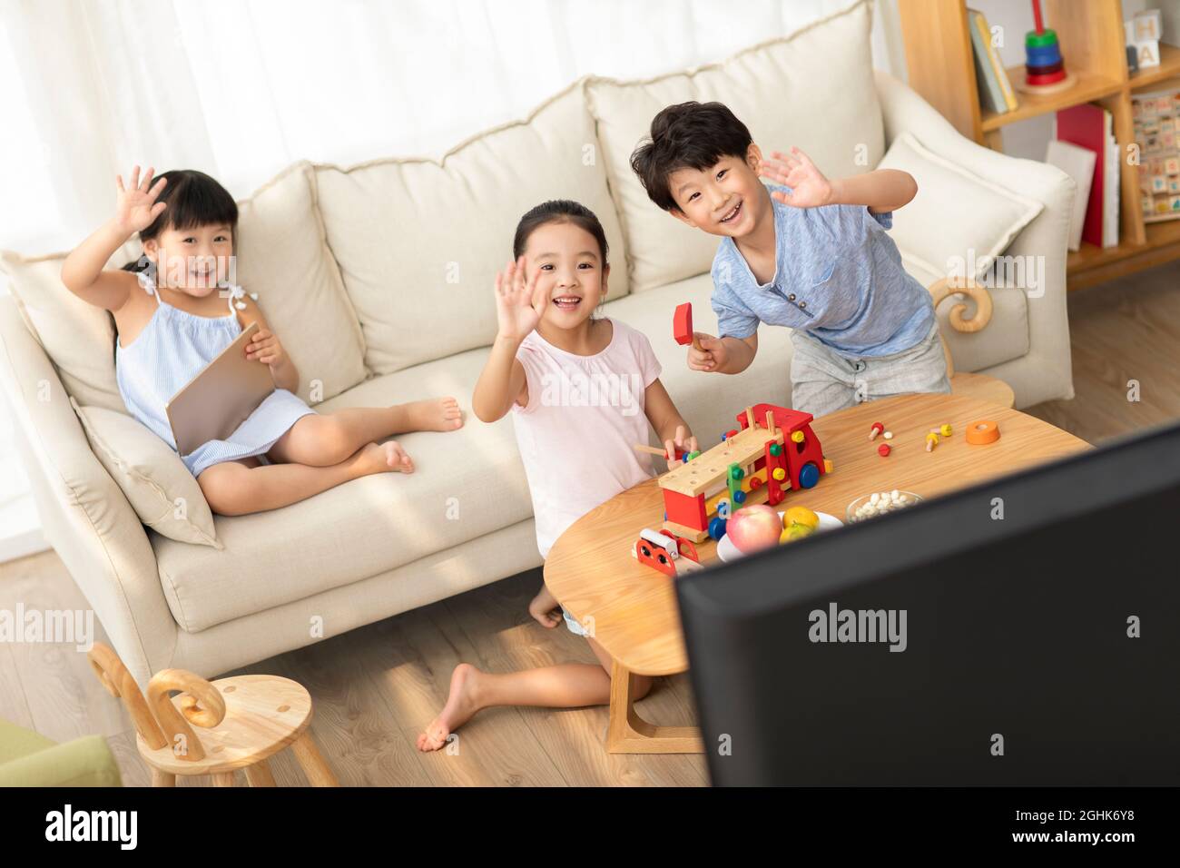 Cute children playing in living room Stock Photo - Alamy