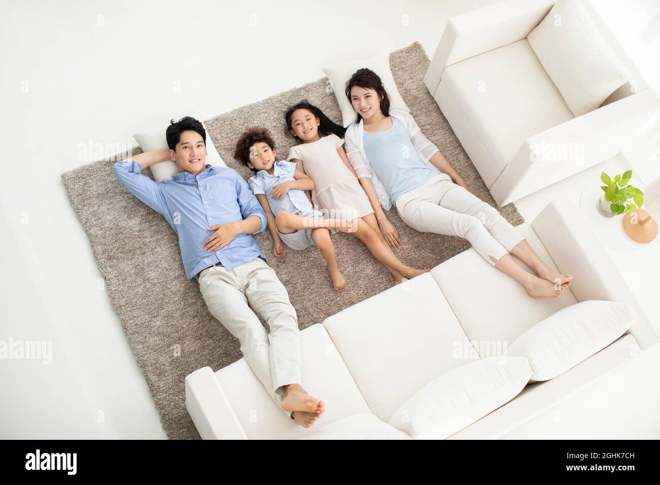 Happy family relaxing in living room Stock Photo - Alamy