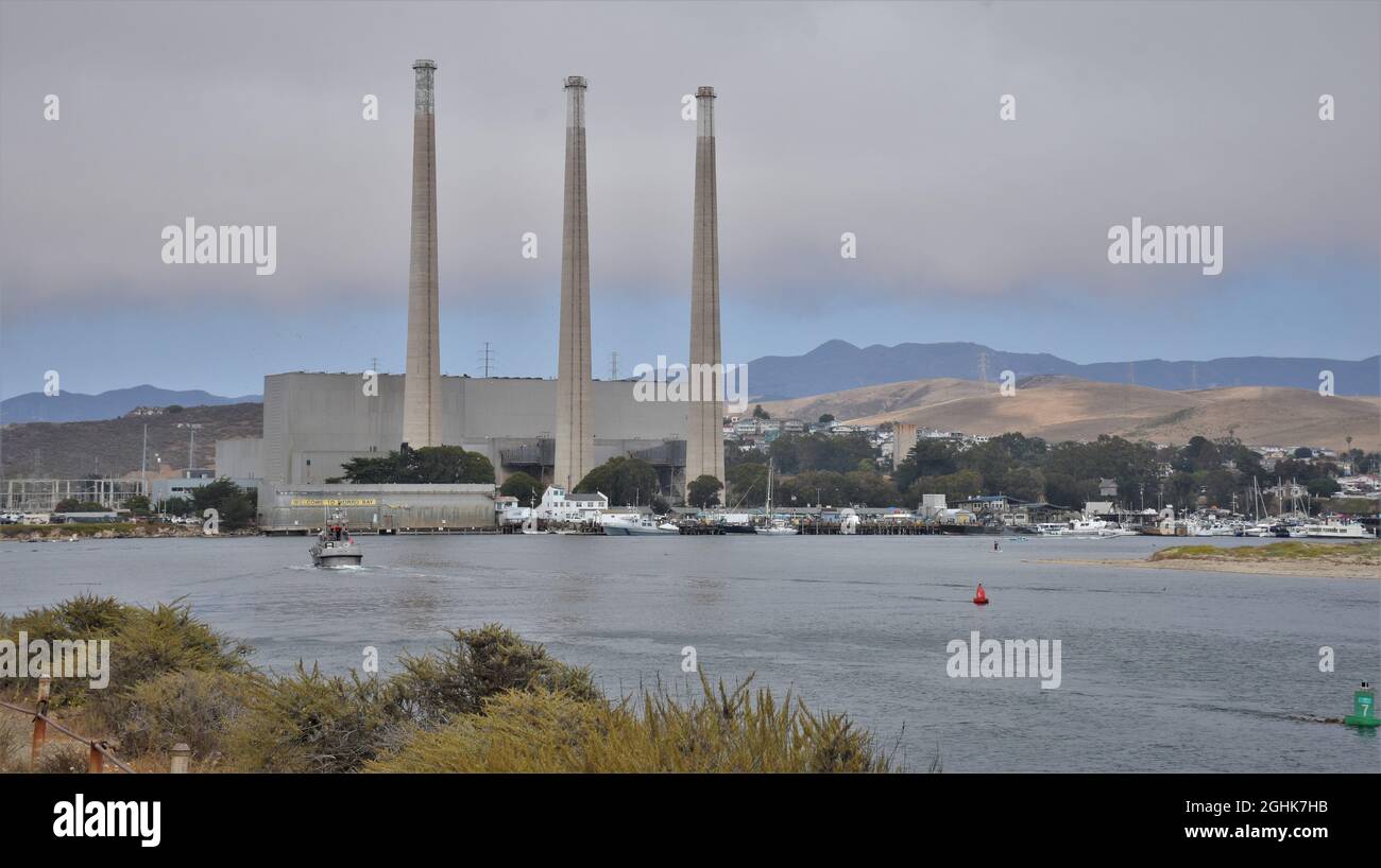 People fishing at the entrance to Morro Bay, with the decommissioned ...