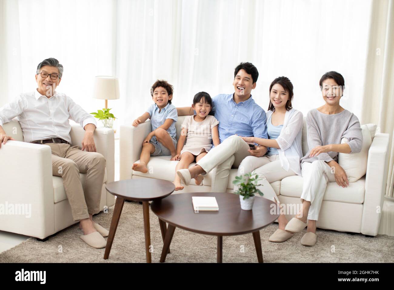 Happy family watching TV at home Stock Photo - Alamy