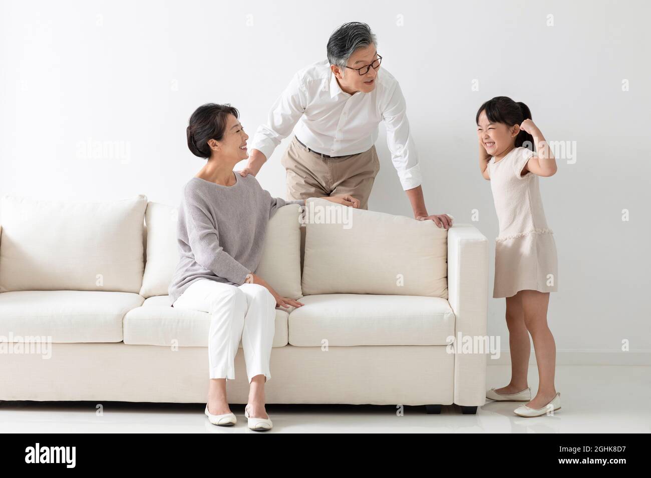 Cheerful grandparents with granddaughter Stock Photo - Alamy