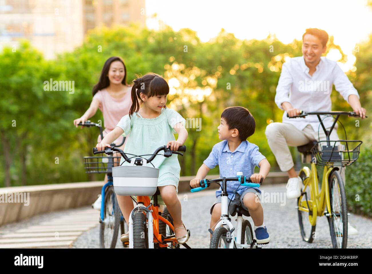 Happy young family riding bikes Stock Photo - Alamy