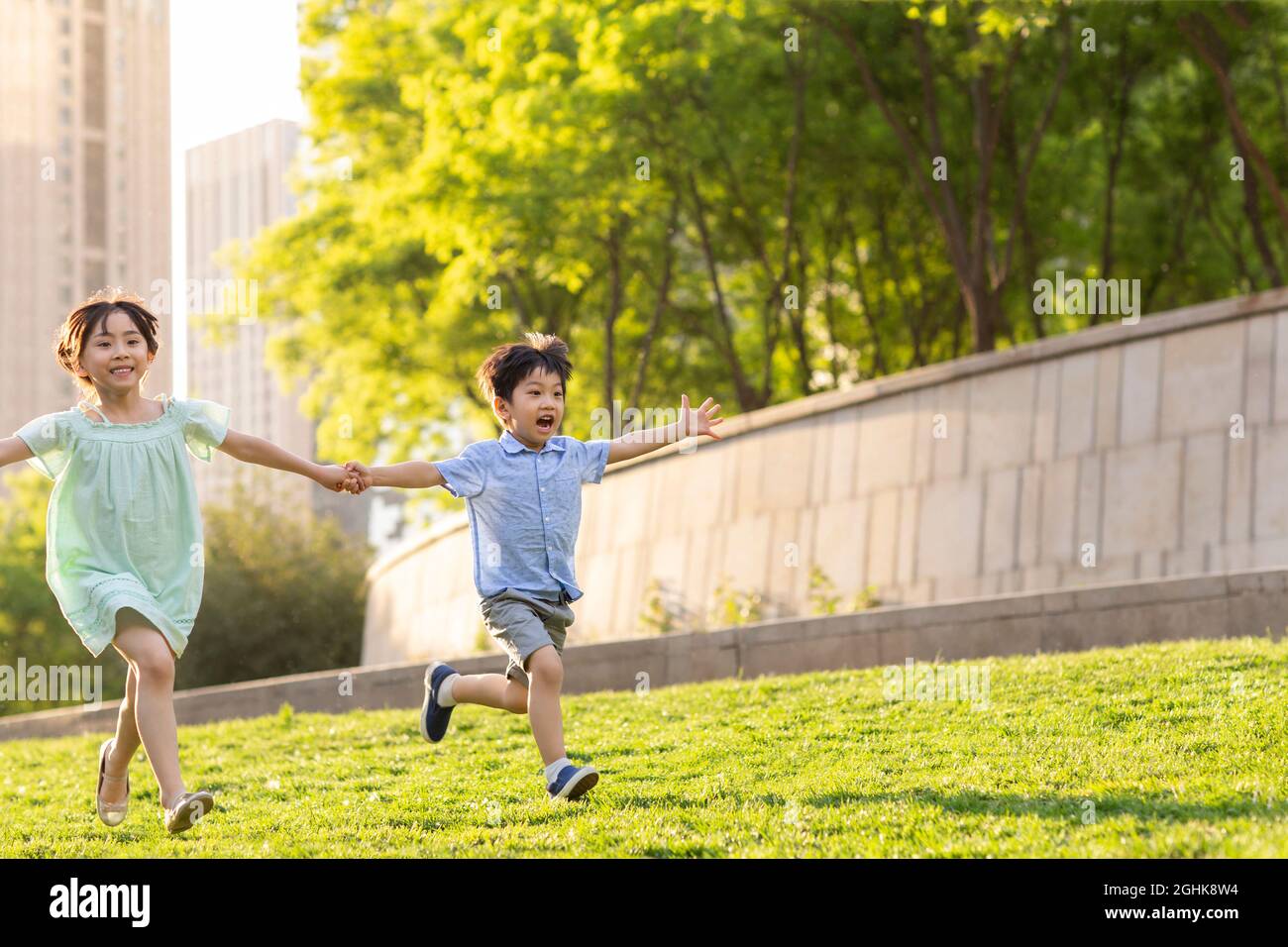 Happy children playing in park Stock Photo - Alamy