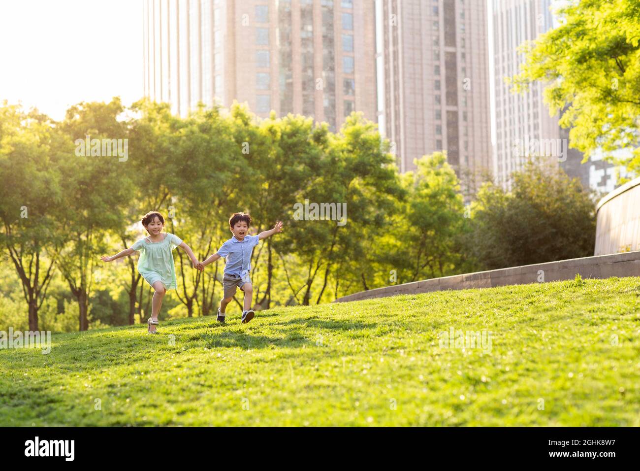 Happy children playing in park Stock Photo - Alamy