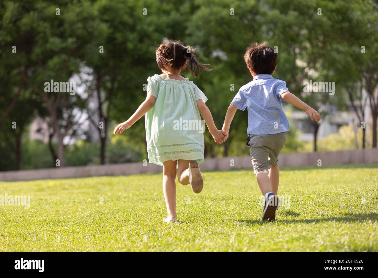 Happy children playing in park Stock Photo - Alamy