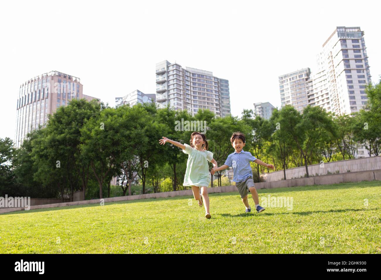 Happy children playing in park Stock Photo - Alamy