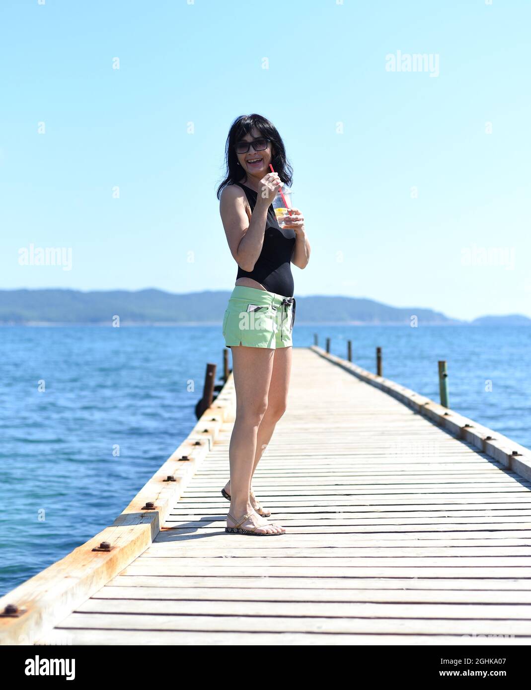 45 Years Old Russian Woman Drinking Lemonad And Standing On A Pier