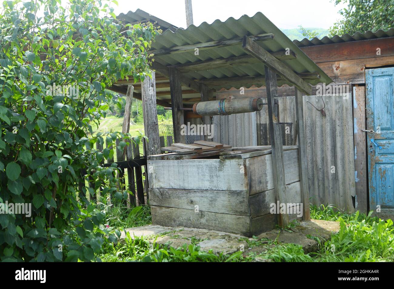 Indoor wooden well in the village Stock Photo - Alamy