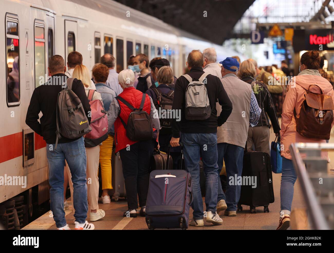 Cologne, Germany. 07th Sep, 2021. Passengers stand by a train at the ...