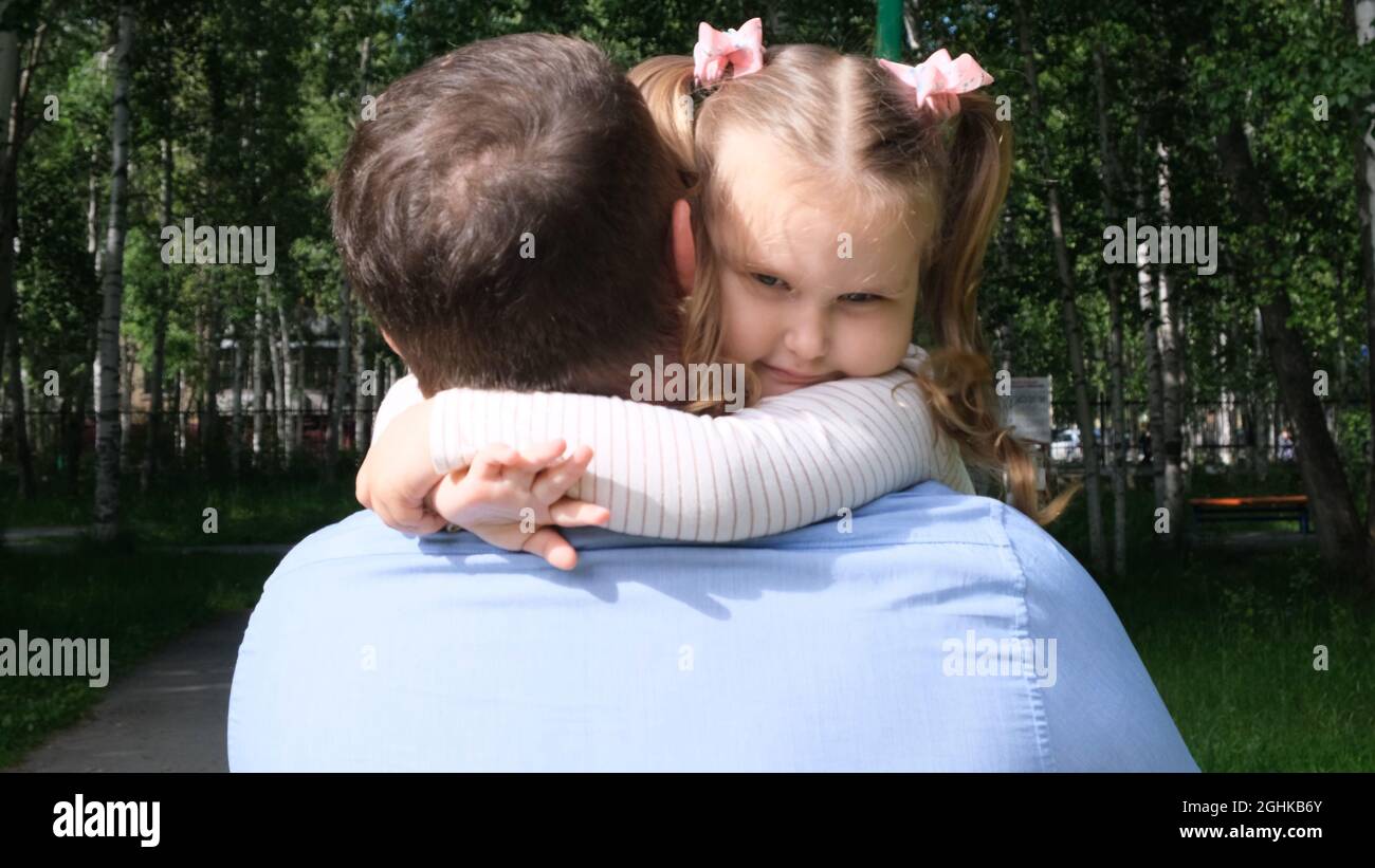 Happy father carrying around his neck and hugging daughter 4-5 years ...