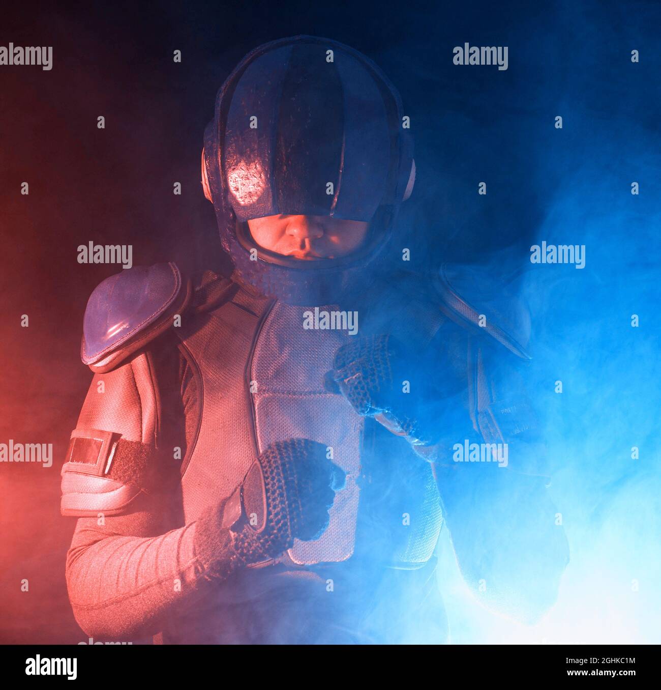 Male robot cop waves and punches his fits in dark. Halfman is ready for ...