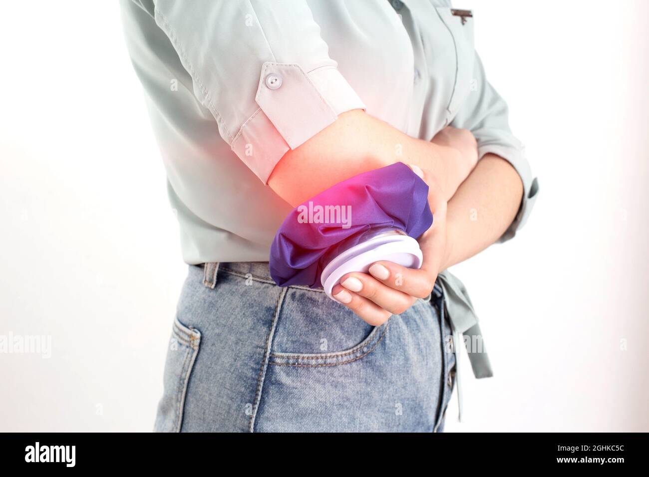 The girl holds a cold compress on the elbow joint for diseases of the ...
