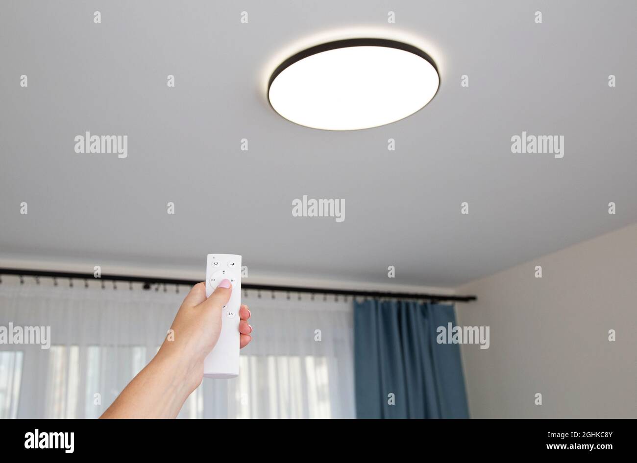 Modern LED ceiling chandelier with on off control panel. Adjusting the ...