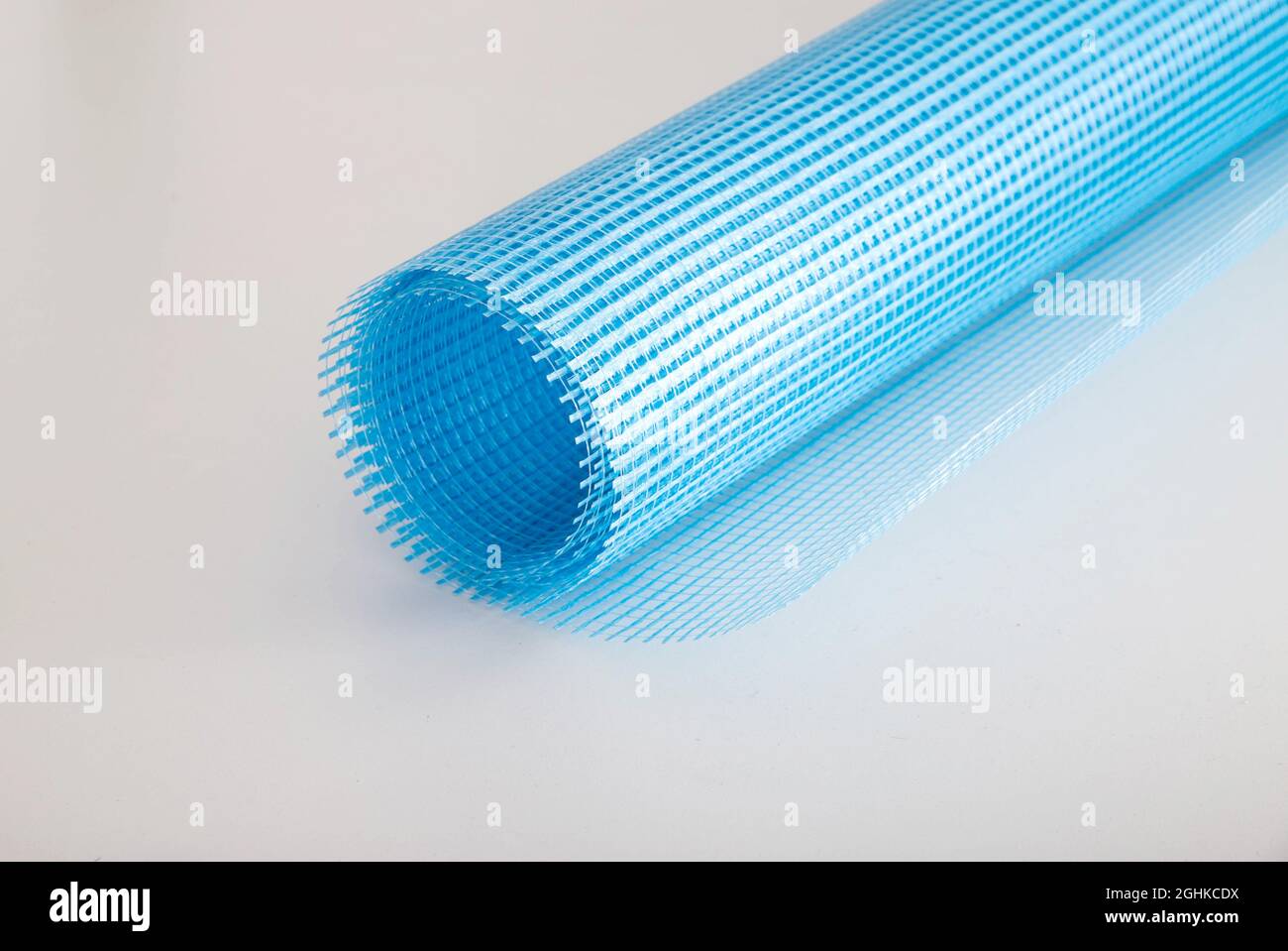 Blue reinforcing construction mesh for wall strengthening on white ...