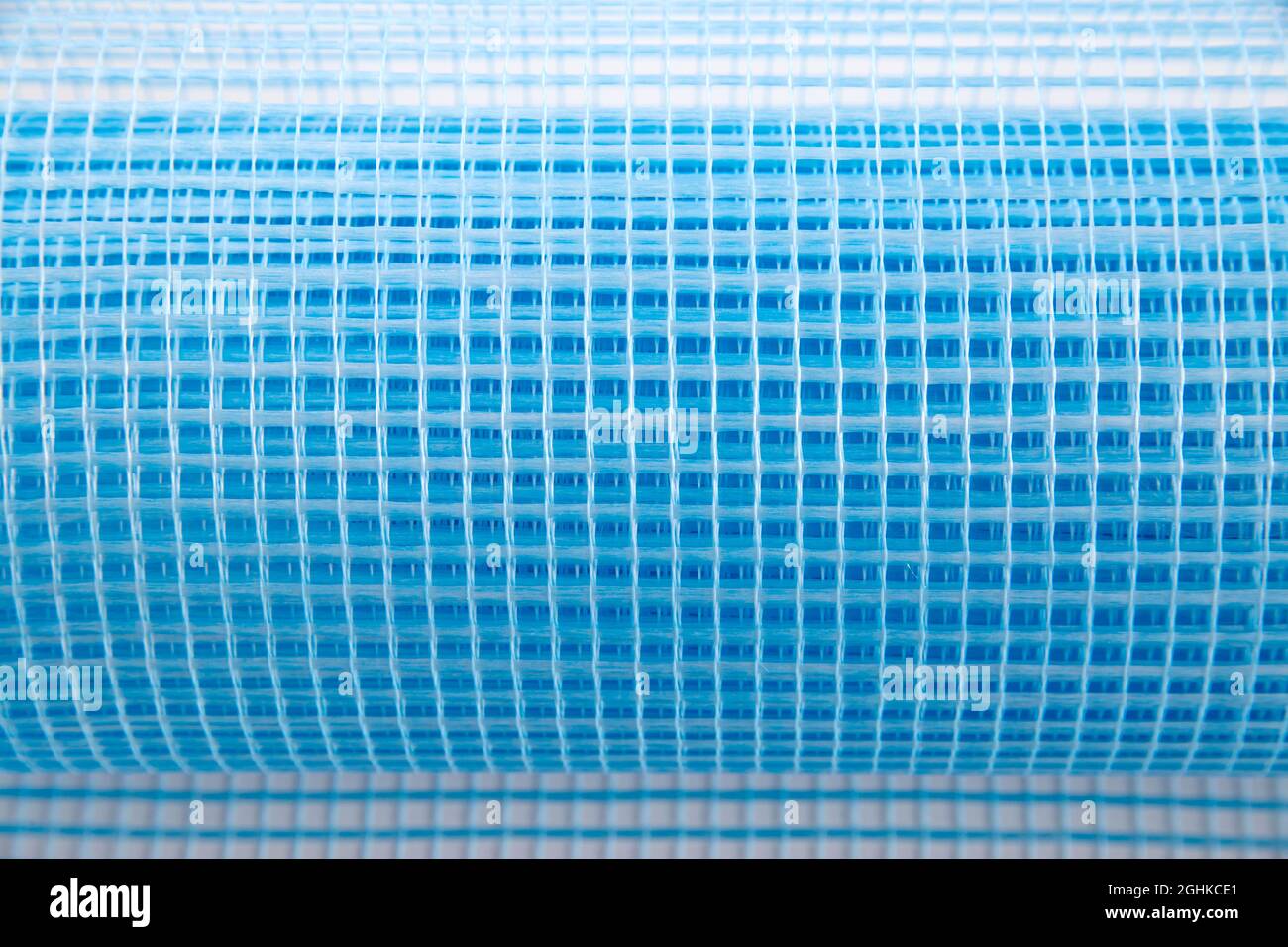 Blue reinforcing construction mesh for wall strengthening on white ...