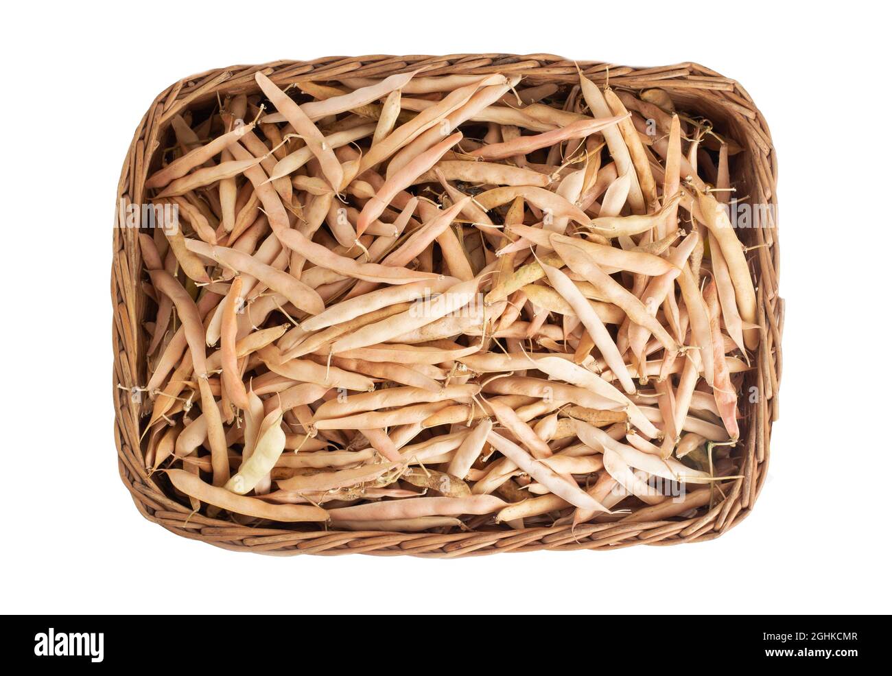 Dry bean pods in a wicker basket on a white background, isolate ...